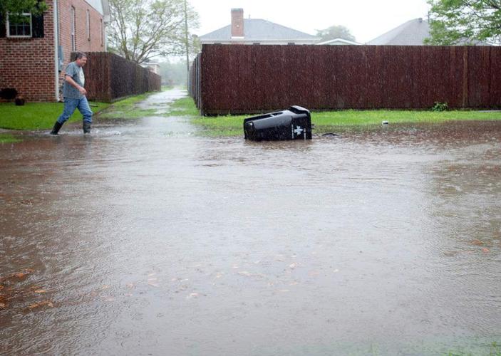 Flooded streets and floating garbage cans: Photos of Friday's soggy ...