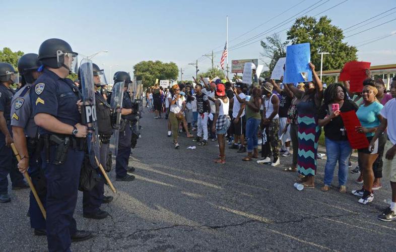 See photos, video as Baton Rouge police officer draws gun, tensions ...
