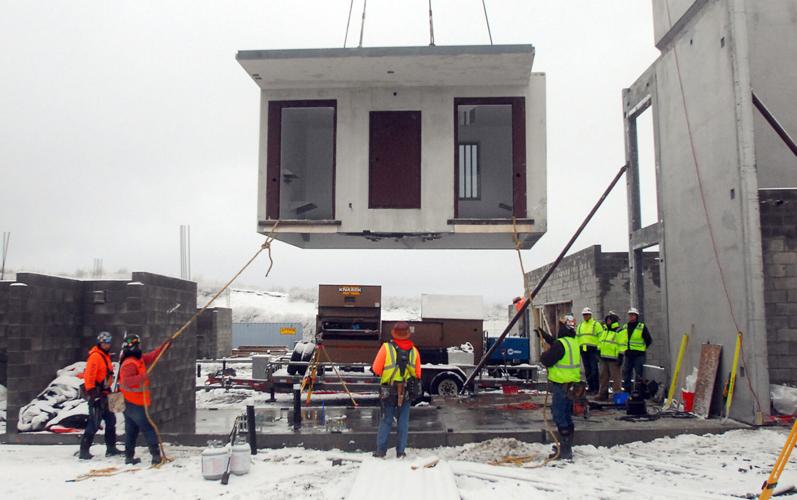 Some assembly required: Officials watch as first cell is installed at ...
