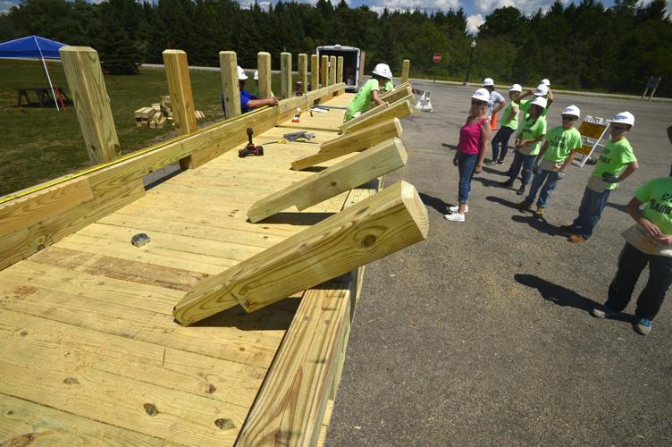 Building a bridge, bonds Students construct bridge over Wetland Berm ...
