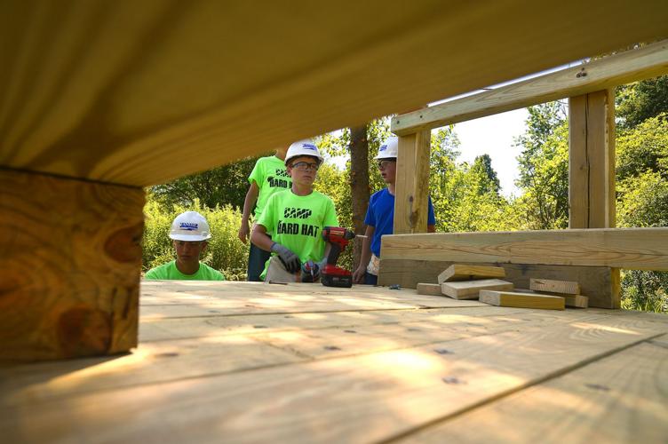 Building a bridge, bonds Students construct bridge over Wetland Berm ...