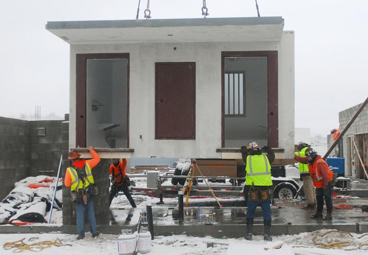 Some assembly required: Officials watch as first cell is installed at ...
