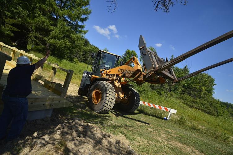 Building a bridge, bonds Students construct bridge over Wetland Berm ...