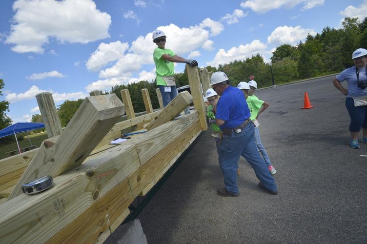Building a bridge, bonds Students construct bridge over Wetland Berm ...