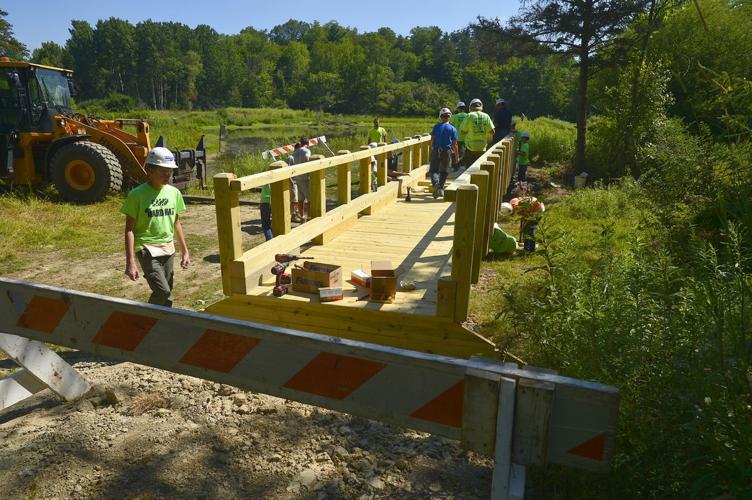 Building a bridge, bonds Students construct bridge over Wetland Berm ...