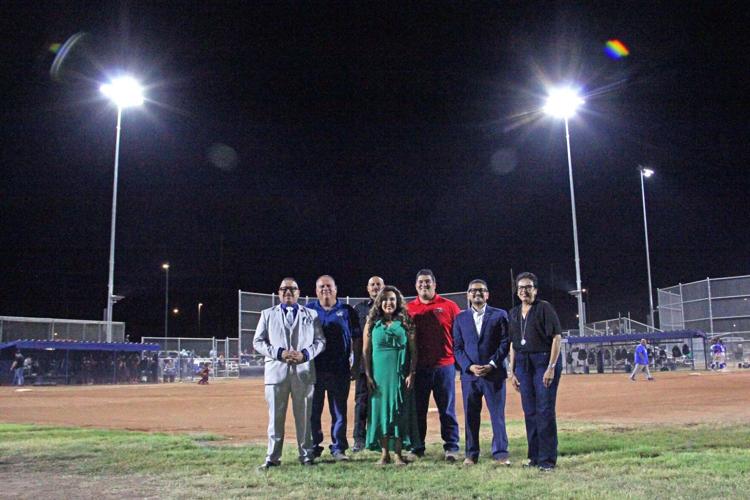 Softball players and dignitaries watch the Debbie Pittman Park light up ...