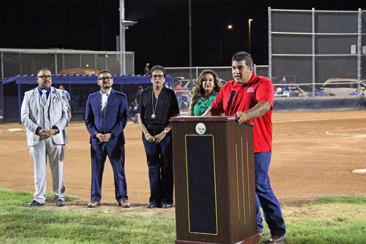 Softball players and dignitaries watch the Debbie Pittman Park light up ...