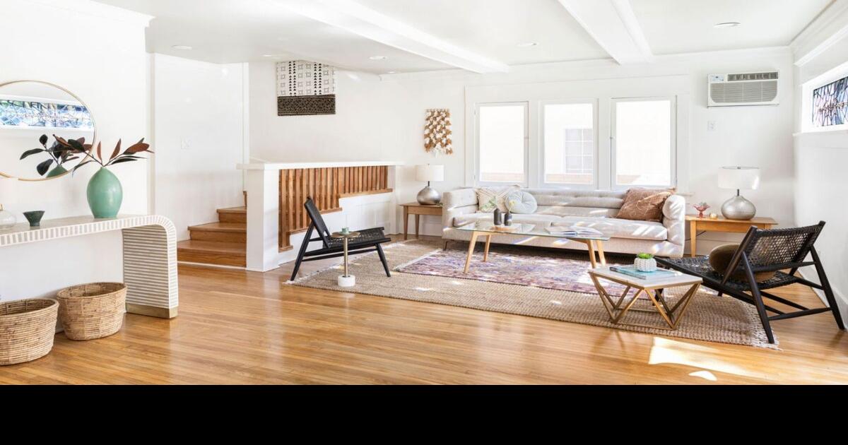 Seating area with couch and hardwood floors | Sponsored ...