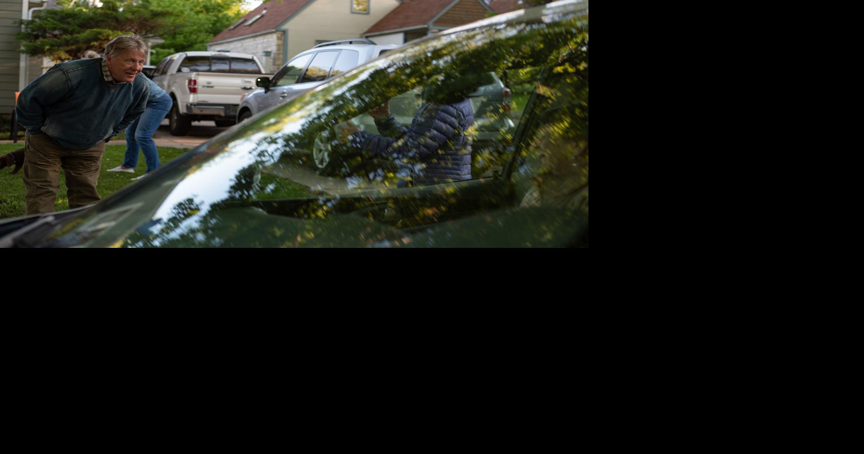 Dr. Steven Short talks to Kay Weigel from his front yard on Friday ...