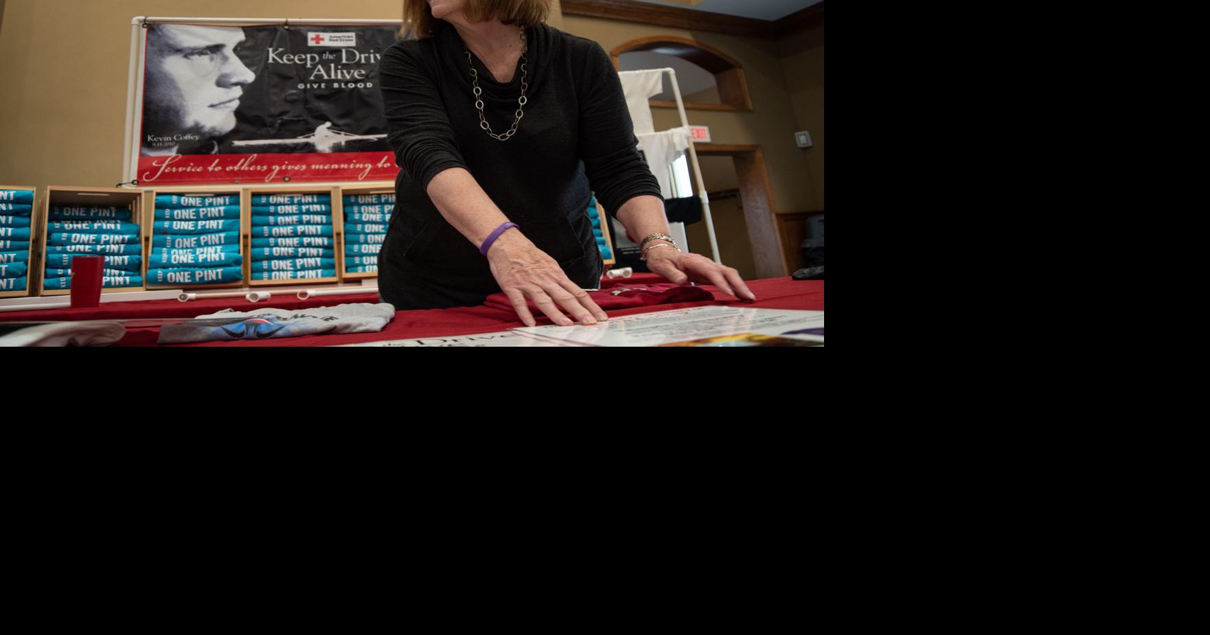 Maxine Coffey, mother of Kevin Coffey, sets up the blood drive booth in ...