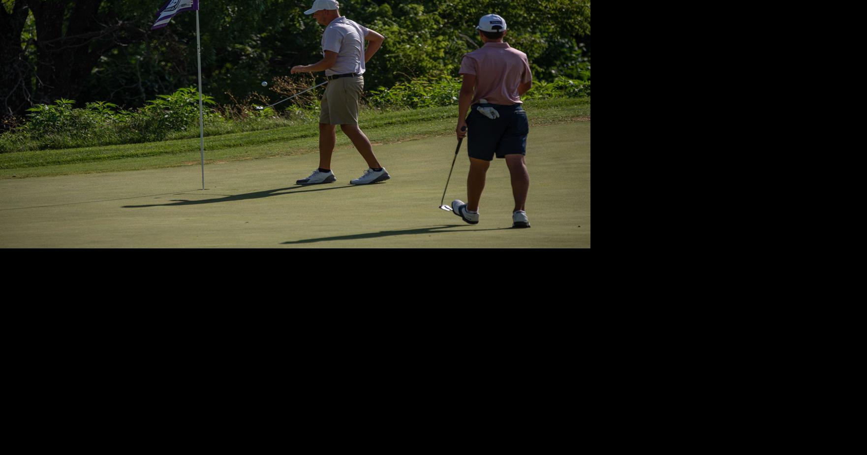 Jared Helin catches his golf ball after putting in the ball on Hole 8 ...