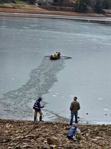 Swan keepers chip through ice at Lake Junaluska to care for the beloved ...