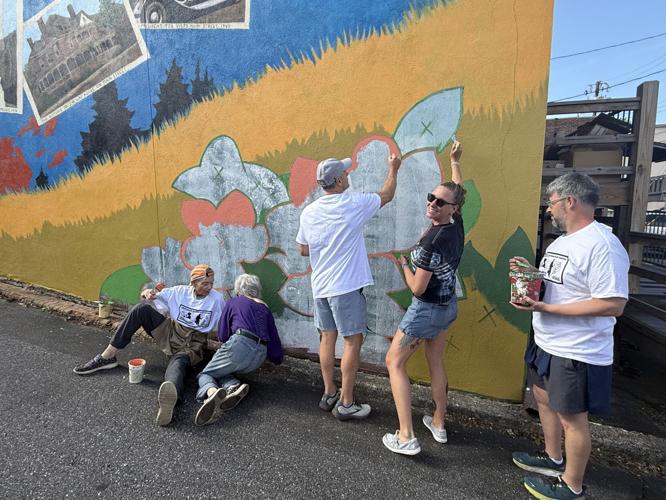 Pitching in to paint: volunteers bring historic Waynesville mural to ...