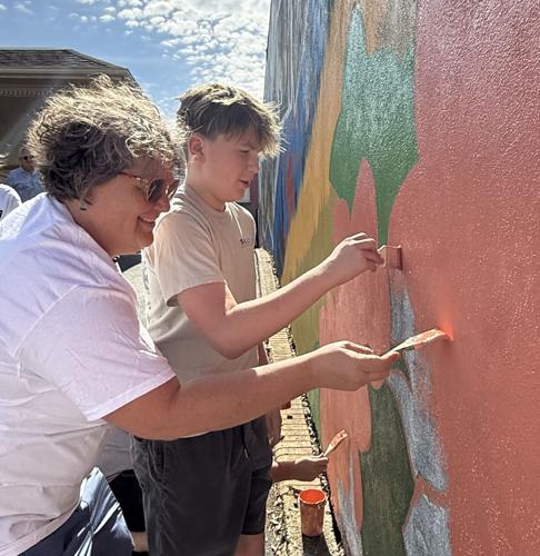 Pitching in to paint: volunteers bring historic Waynesville mural to ...