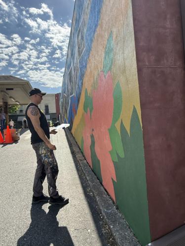 Pitching in to paint: volunteers bring historic Waynesville mural to ...