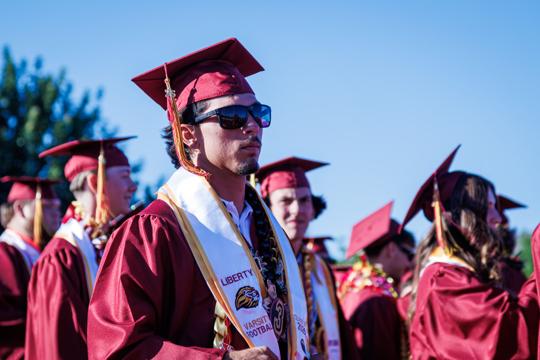 Liberty's seniors toss their caps and celebrate during their graduation ...