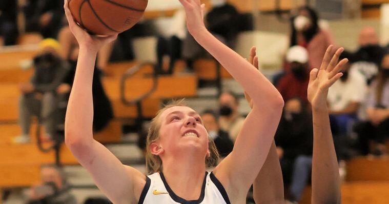 Heritage High School girls basketball player Amanda Muse stands above ...