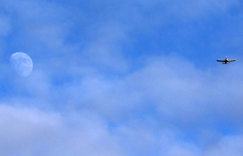PHOTOS: The moon watches over the flight of this plane | Westerly ...