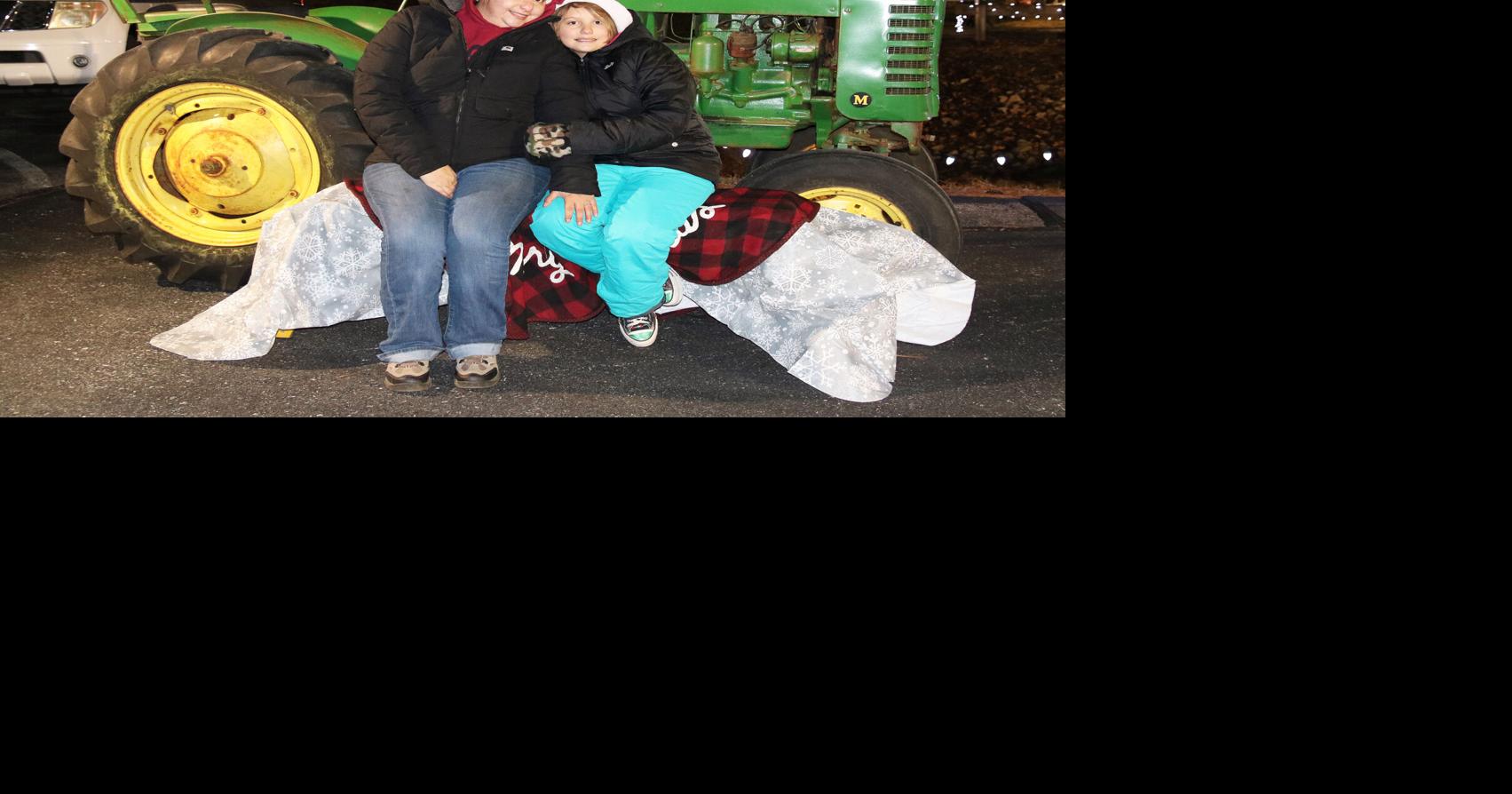 Kendall and Emily Stone pose for a photo sitting on a bale of hay ...
