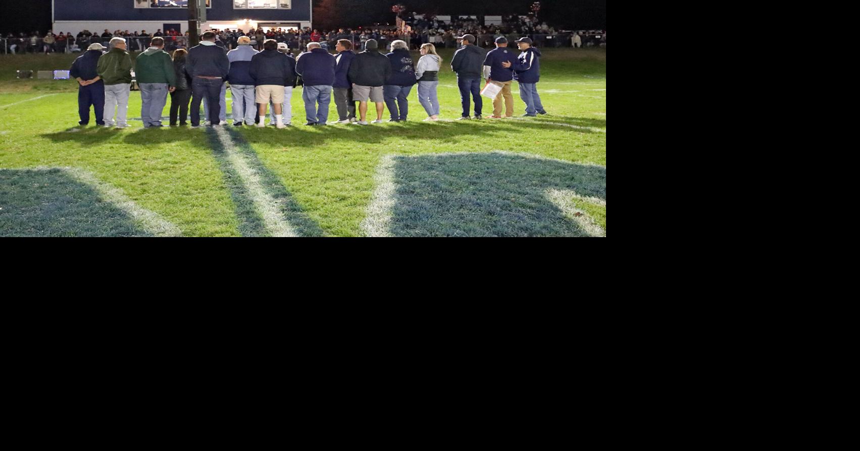 Coach Joe Vacca stands with family members and many of the coaches he ...