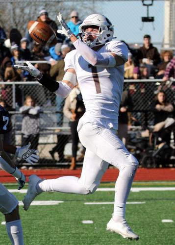 Stonington senior Cole Phelan (1) makes a leaping catch on his way to ...