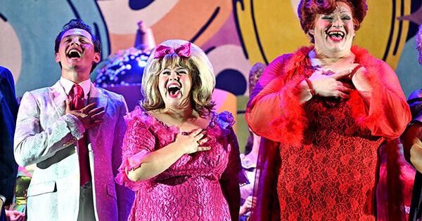 Dominic Young portraying Link Larkin, Niki Metcalf as Tracy Turnblad ...