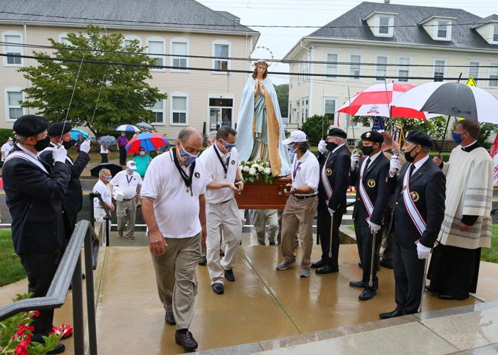 PHOTOS: Maria Assunta Society's 100th annual procession braves the rain ...