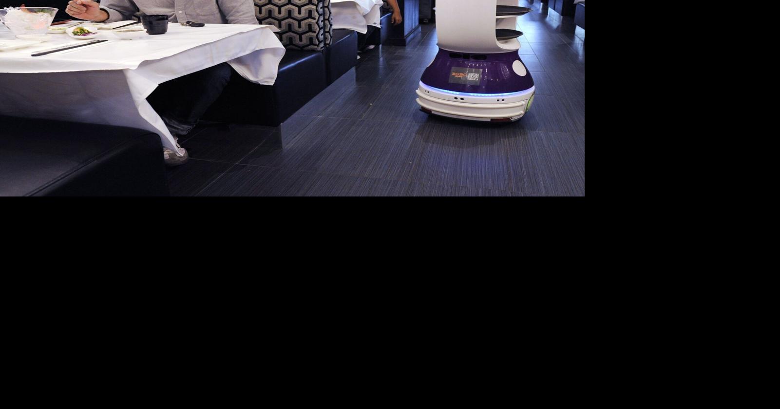 Robots serve customers at the new Robo Sushi in North York