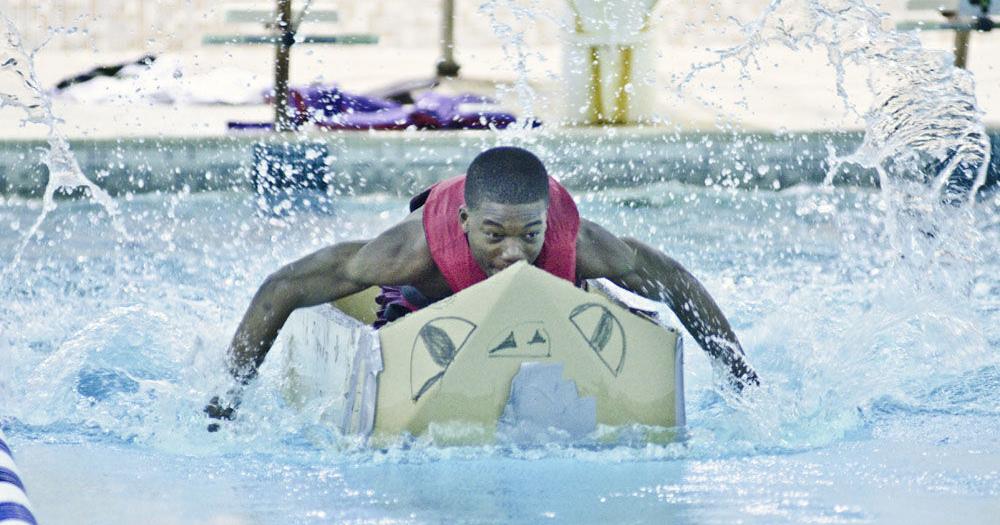 Catholic board students test our their cardboard boat designs during ...