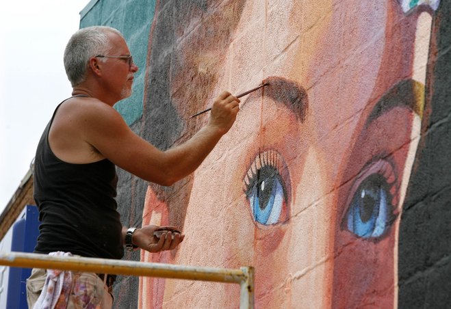 Muskogee artist Lance Hunter paints a classic looking mural