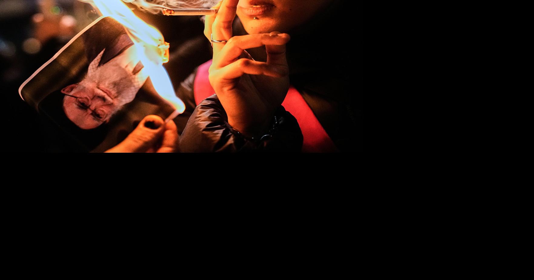 Woman burns photo, lights cigarette and becomes a symbol