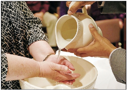 Medical workers' hands anointed for healing touch