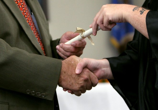 Inmates receive GEDs at graduation ceremony behind bars