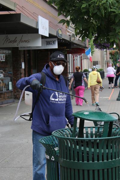 Taking the COVID-19 fight to the streets: A city employee sanitizes the ...