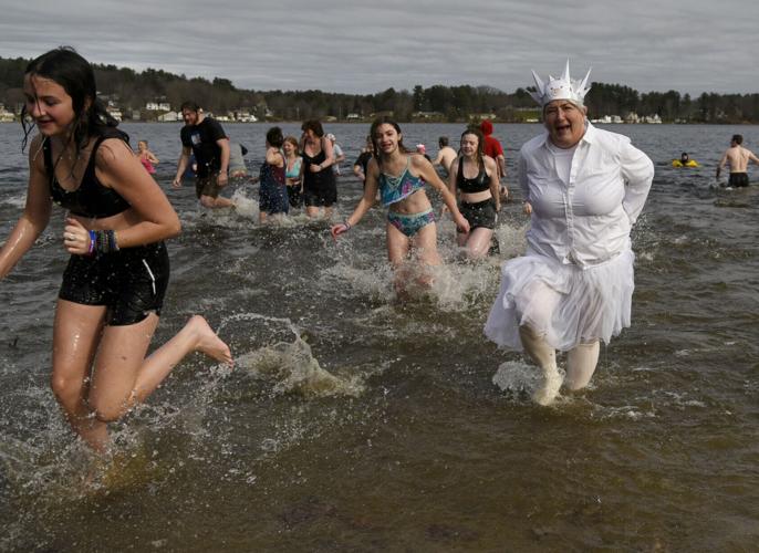 Taking the plunge....Dozens do more than dip their toes in the water ...