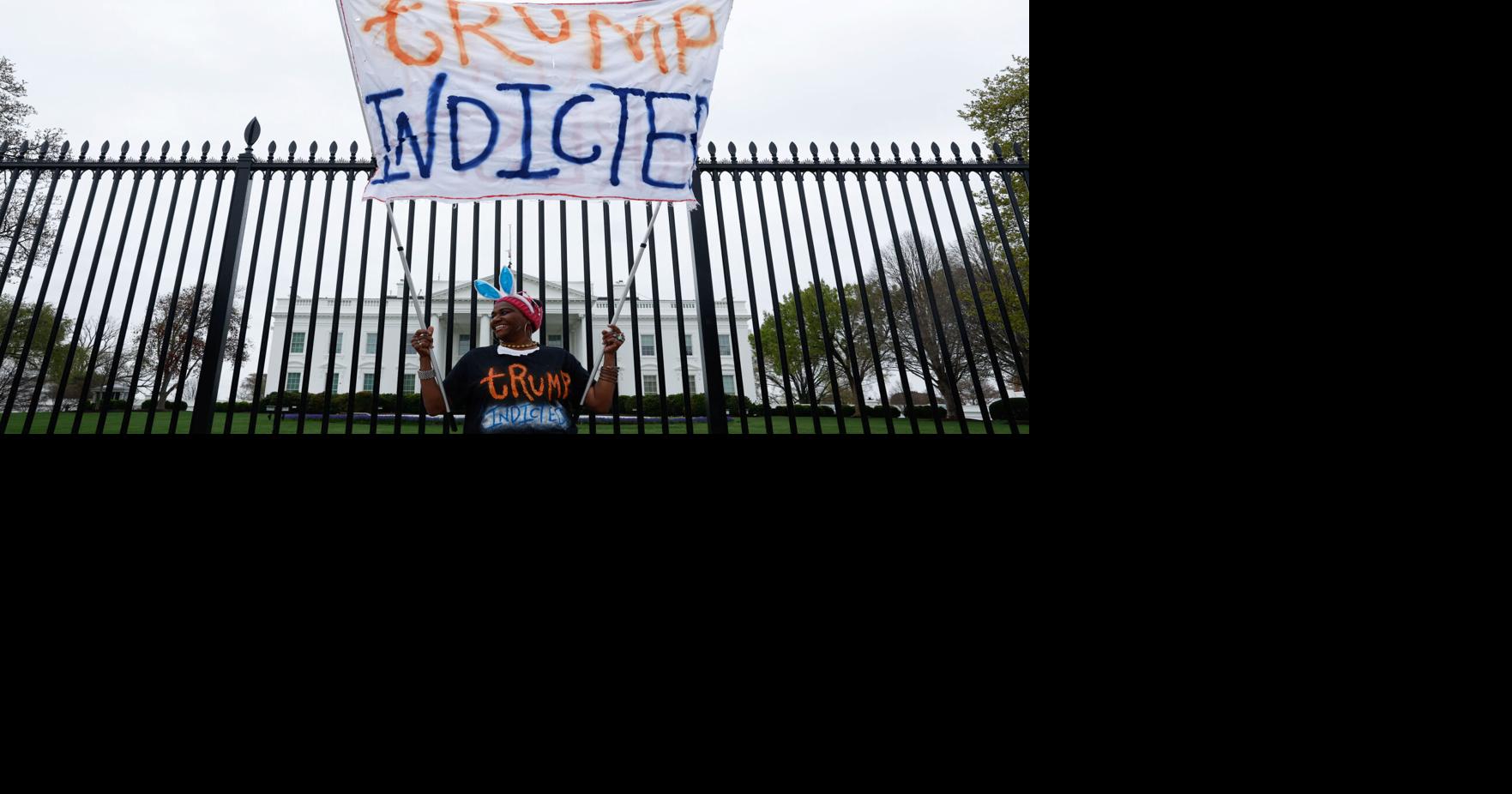 Nadine Seiler holds a "Trump Indicted" sign in front of the White House ...