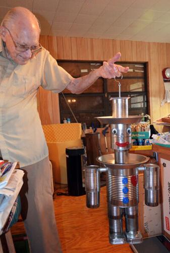 Tin can art man adds birdfeeders to collection | | vieravoice.com