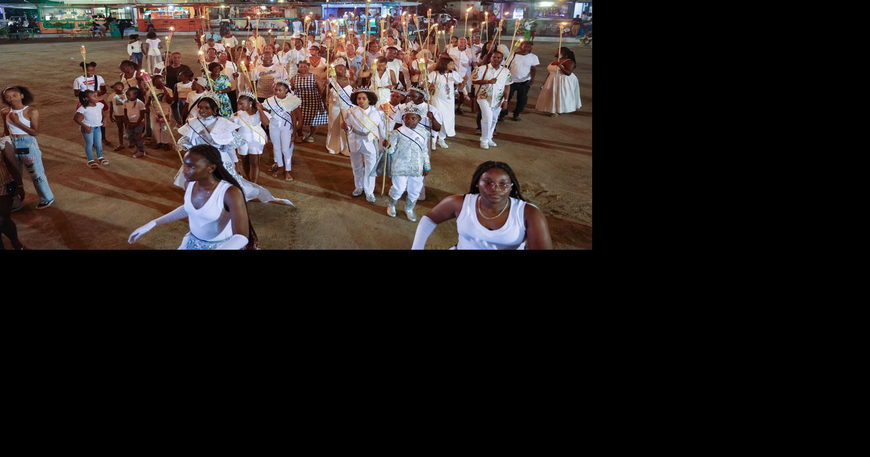 All-white torchlight procession draws largest crowd in recent years ...