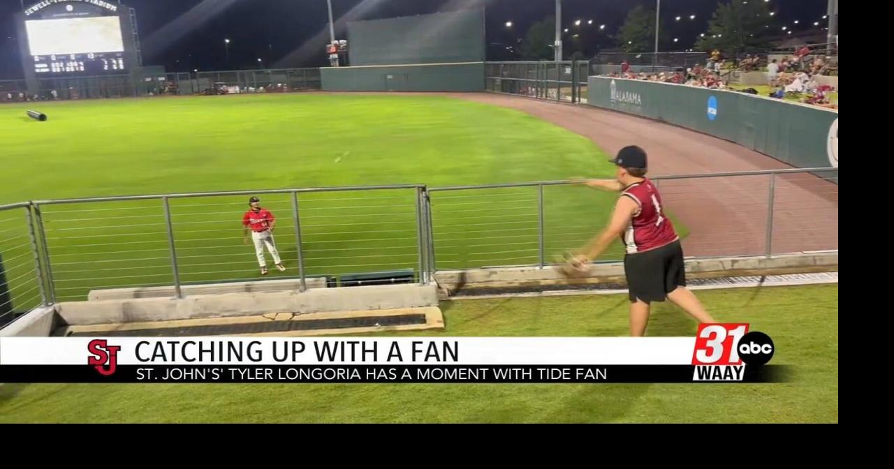 St. John's player and an Alabama fan share a game of catch during ...