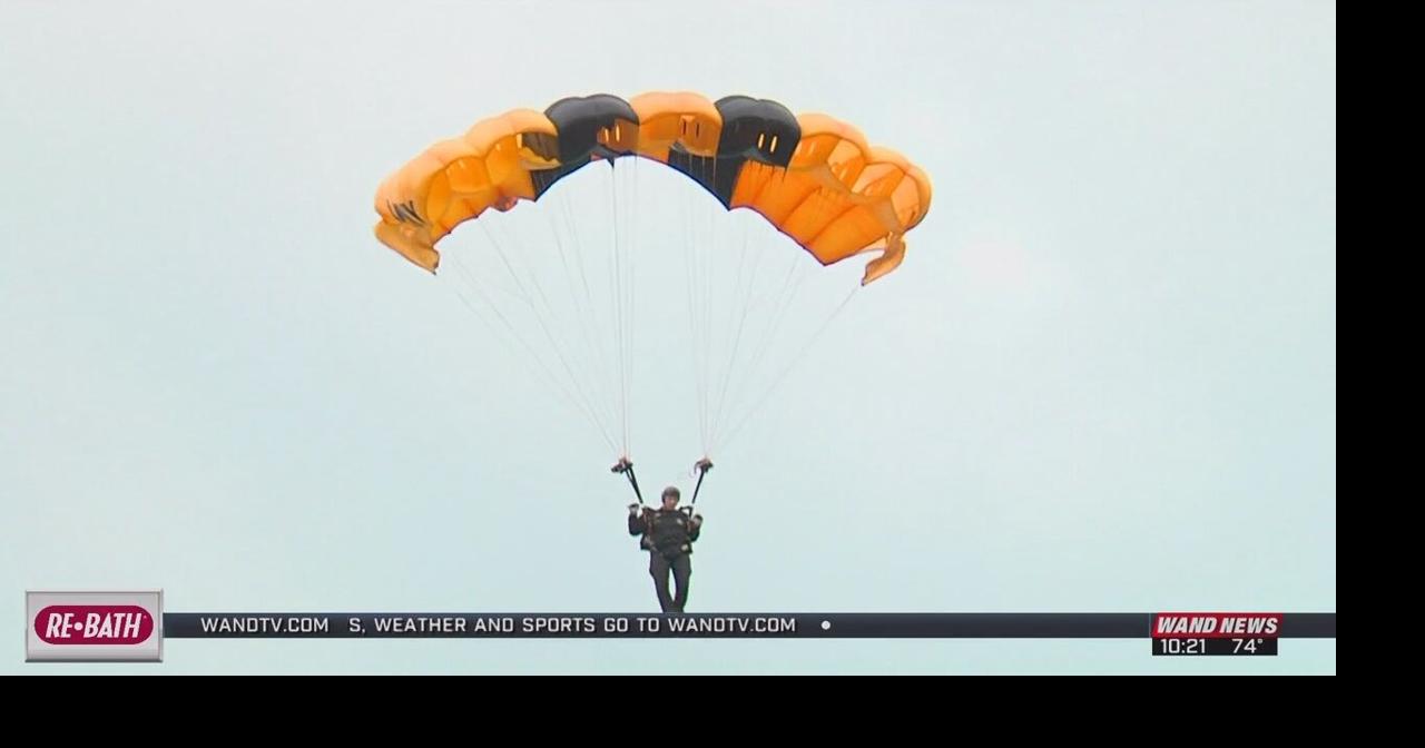 Military members parachute to amphitheatre stage in air show promotion ...