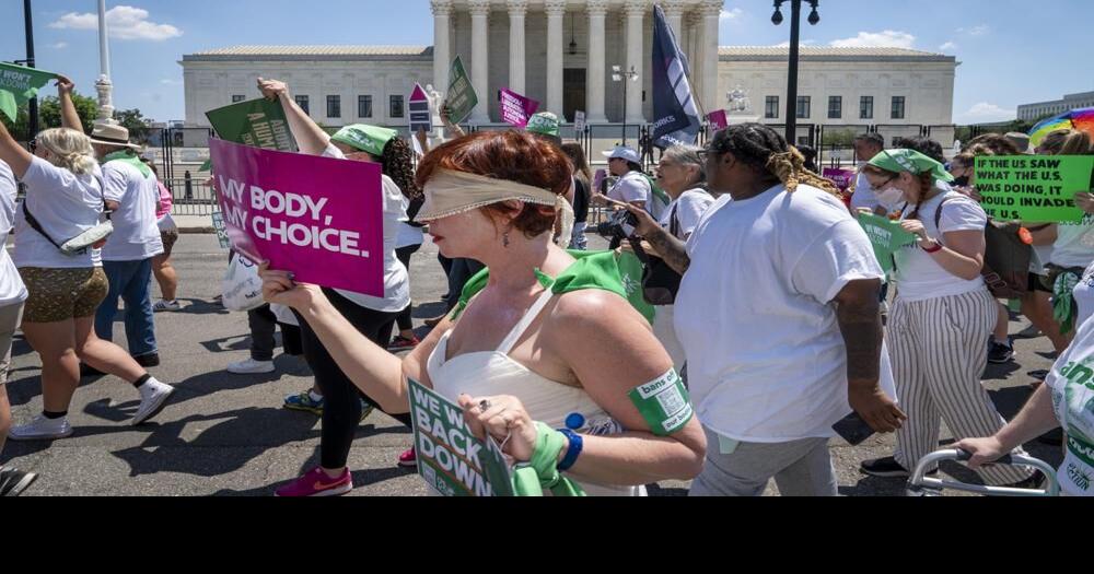 Woman wearing a 'Lady Justice' costume as she marches past Supreme ...