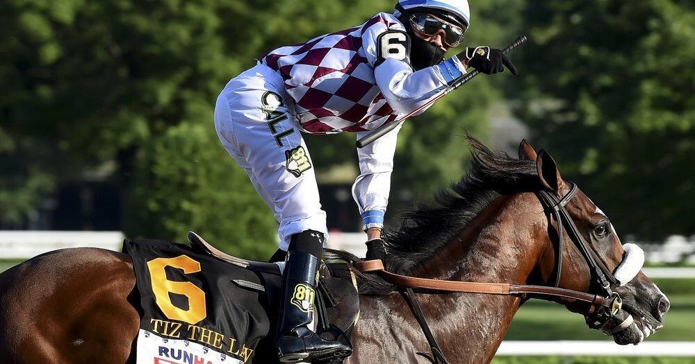 Jockey Manny Franco reacts after crossing the finish line with Tiz the ...