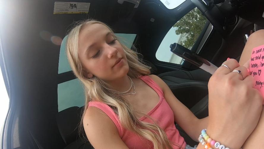 Kind teen sticks positive Post-Its on cars and drive-thrus around ...