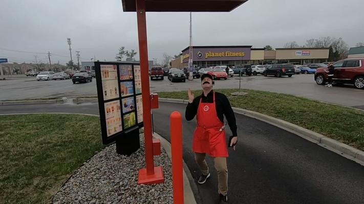 WDRB's Keith Kaiser helps people in line at Scooter's Coffee get ready ...