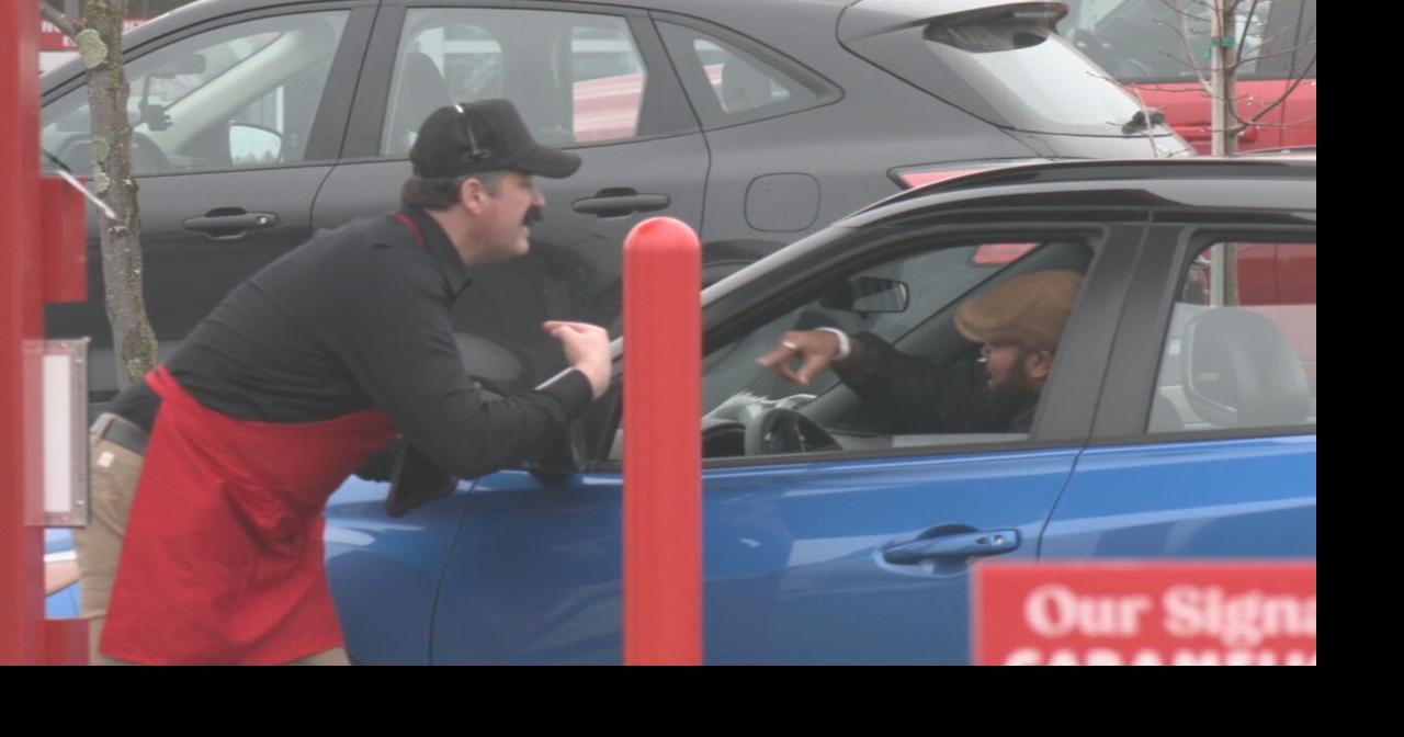 WDRB's Keith Kaiser helps people in line at Scooter's Coffee get ready ...