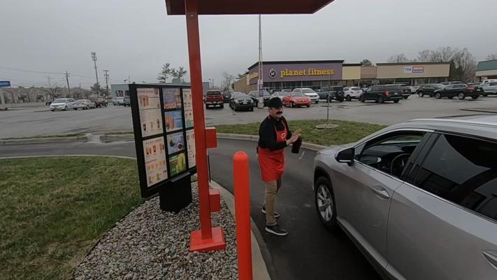 WDRB's Keith Kaiser helps people in line at Scooter's Coffee get ready ...