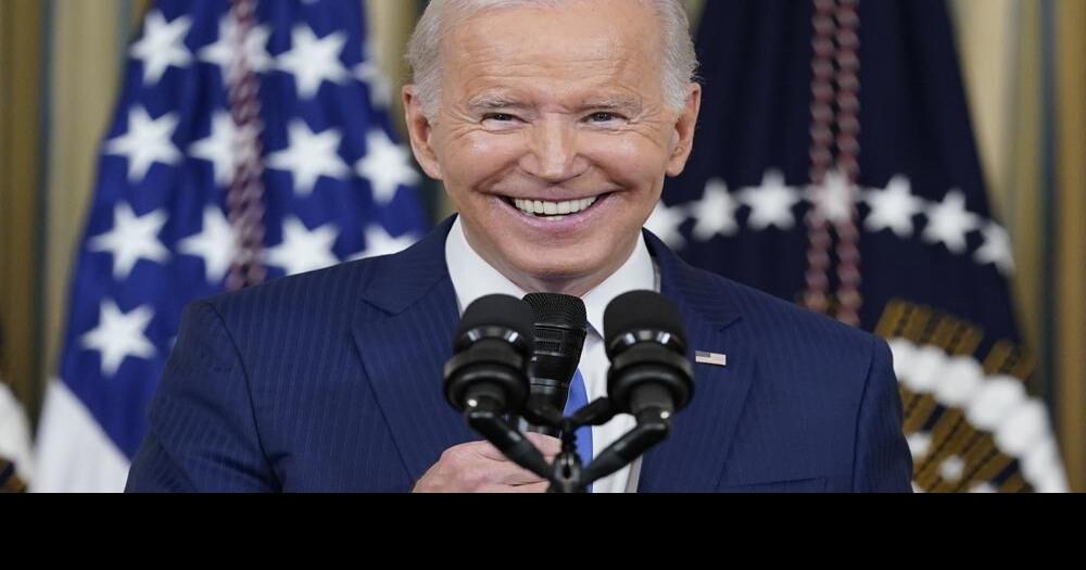 President Joe Biden smiles as he speaks in the State Dining Room.jpeg ...