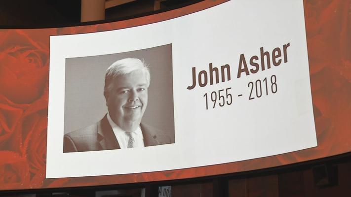 Louisville honors the late John Asher with Hometown Hero banner at ...