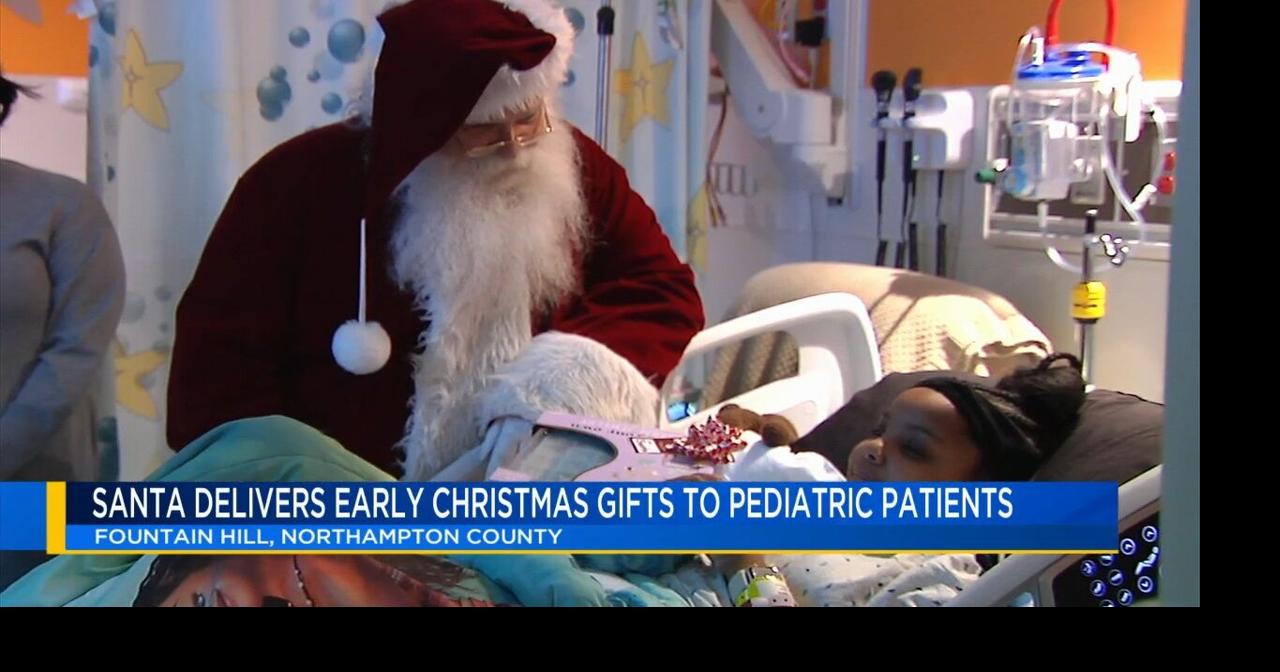 Santa Claus brings early Christmas gifts to the children at St. Luke's ...