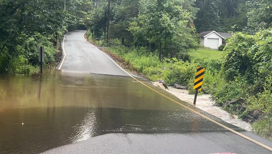 Fast-moving storm sends water rushing across road, knocks down trees in ...